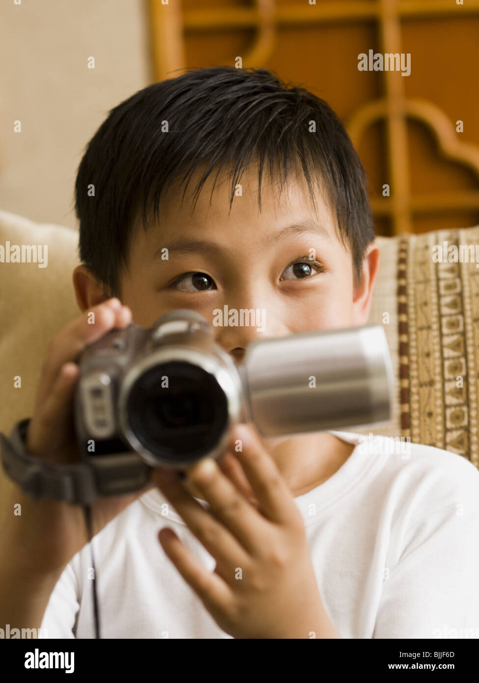 Boy with video camera smiling Stock Photo - Alamy