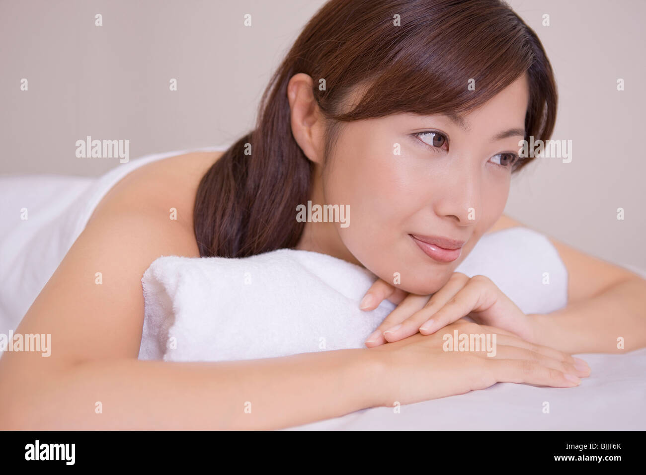 Young woman lying on front Stock Photo - Alamy