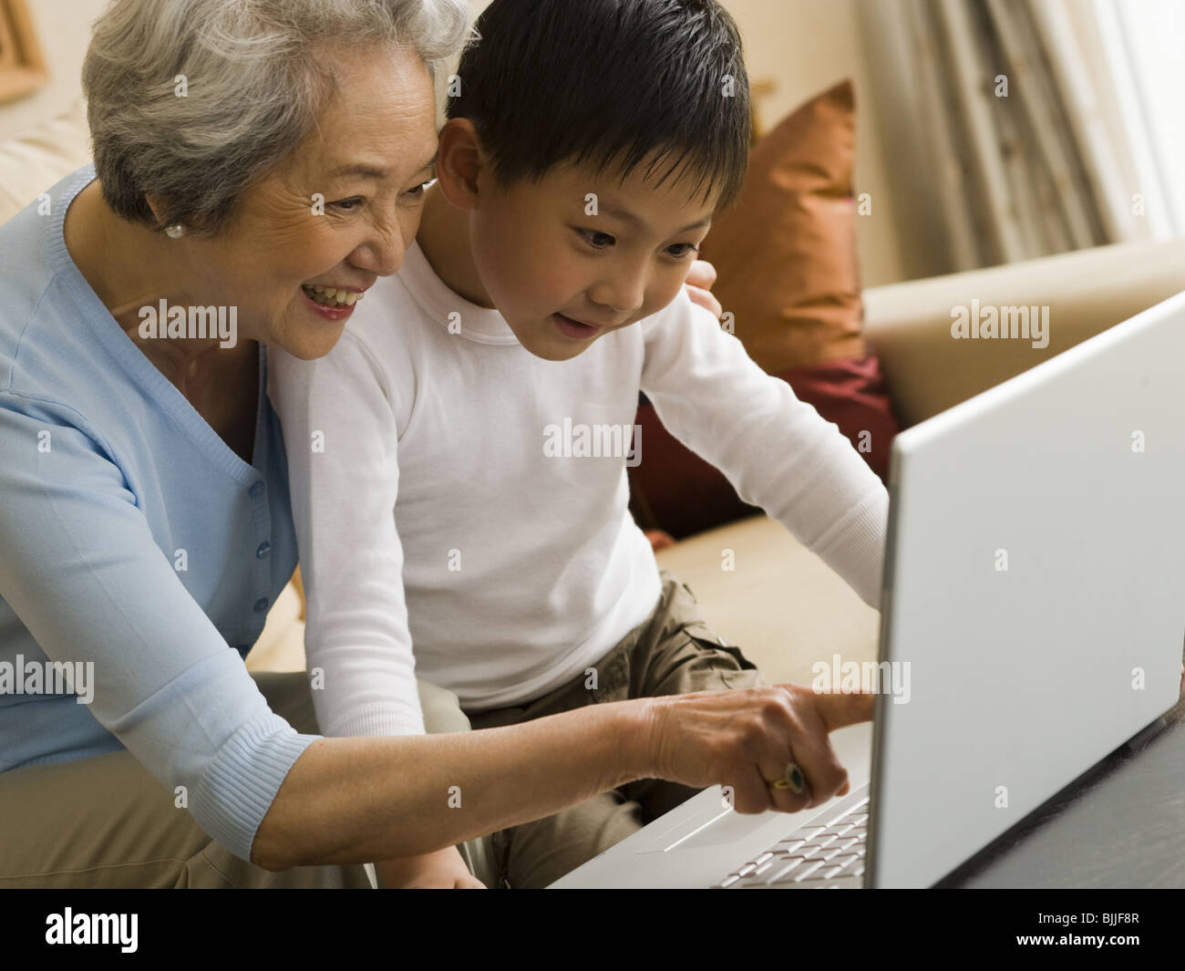 Grandmother and grandson with laptop Stock Photo - Alamy
