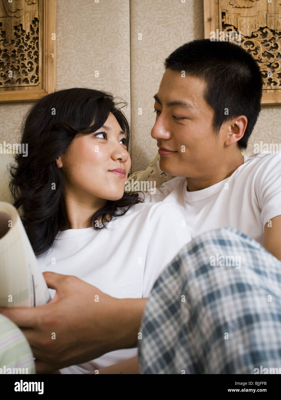 Couple in bed snuggling reading hi-res stock photography and images - Alamy