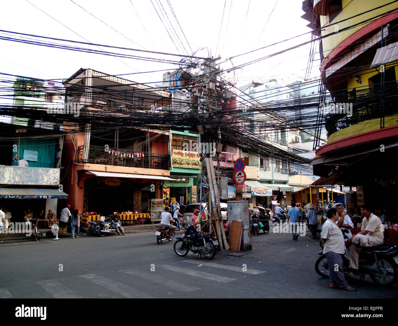 Electricity and telephone cables running above a street in Saigon or Ho ...