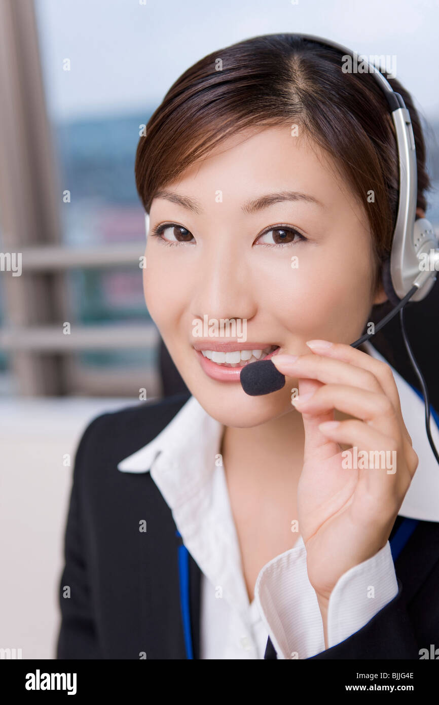 Young woman talking with headset Stock Photo - Alamy