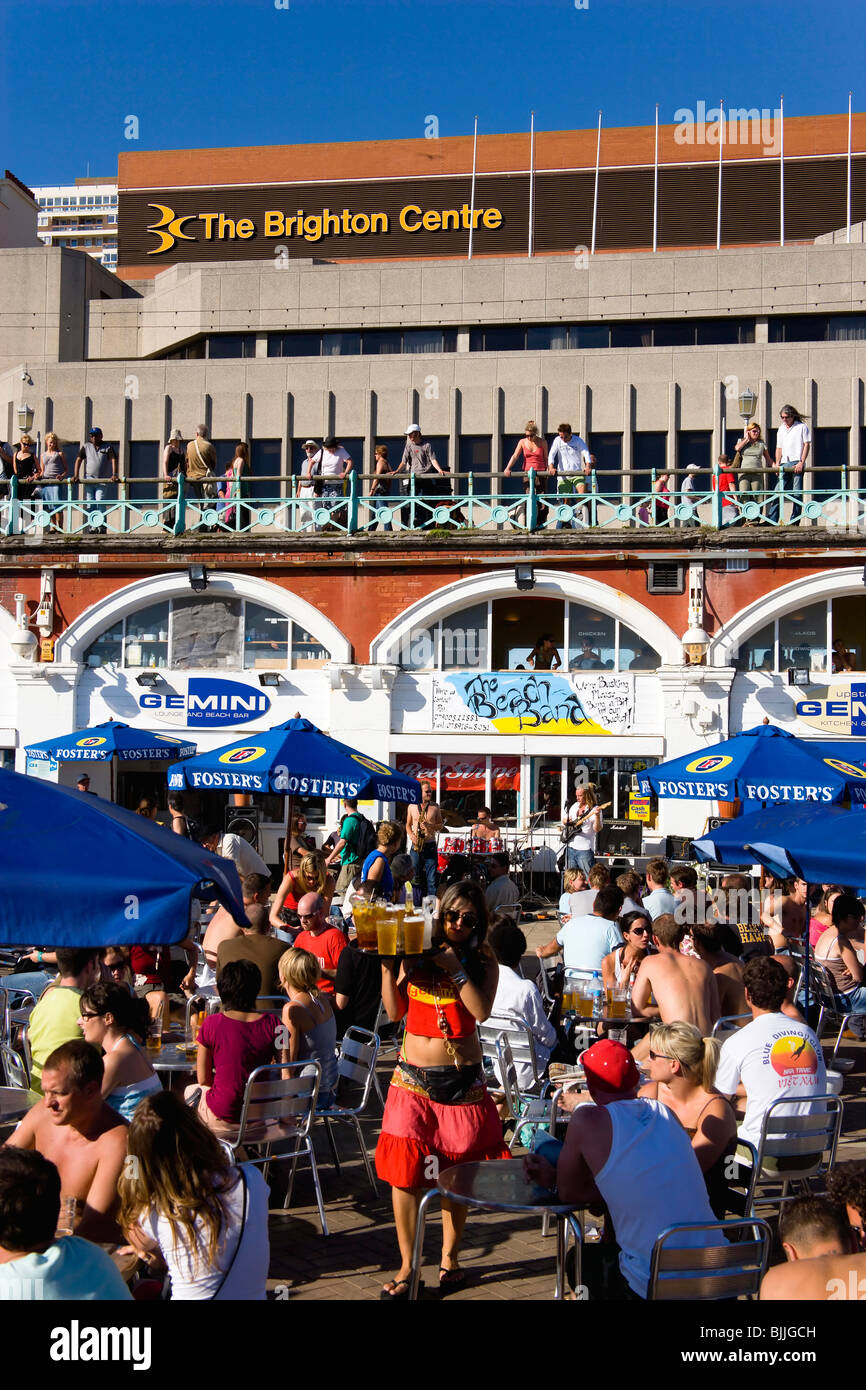England, East Sussex, Brighton, People sitting under sun shade ...