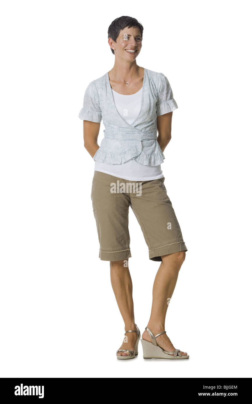 Woman standing and smiling Stock Photo - Alamy