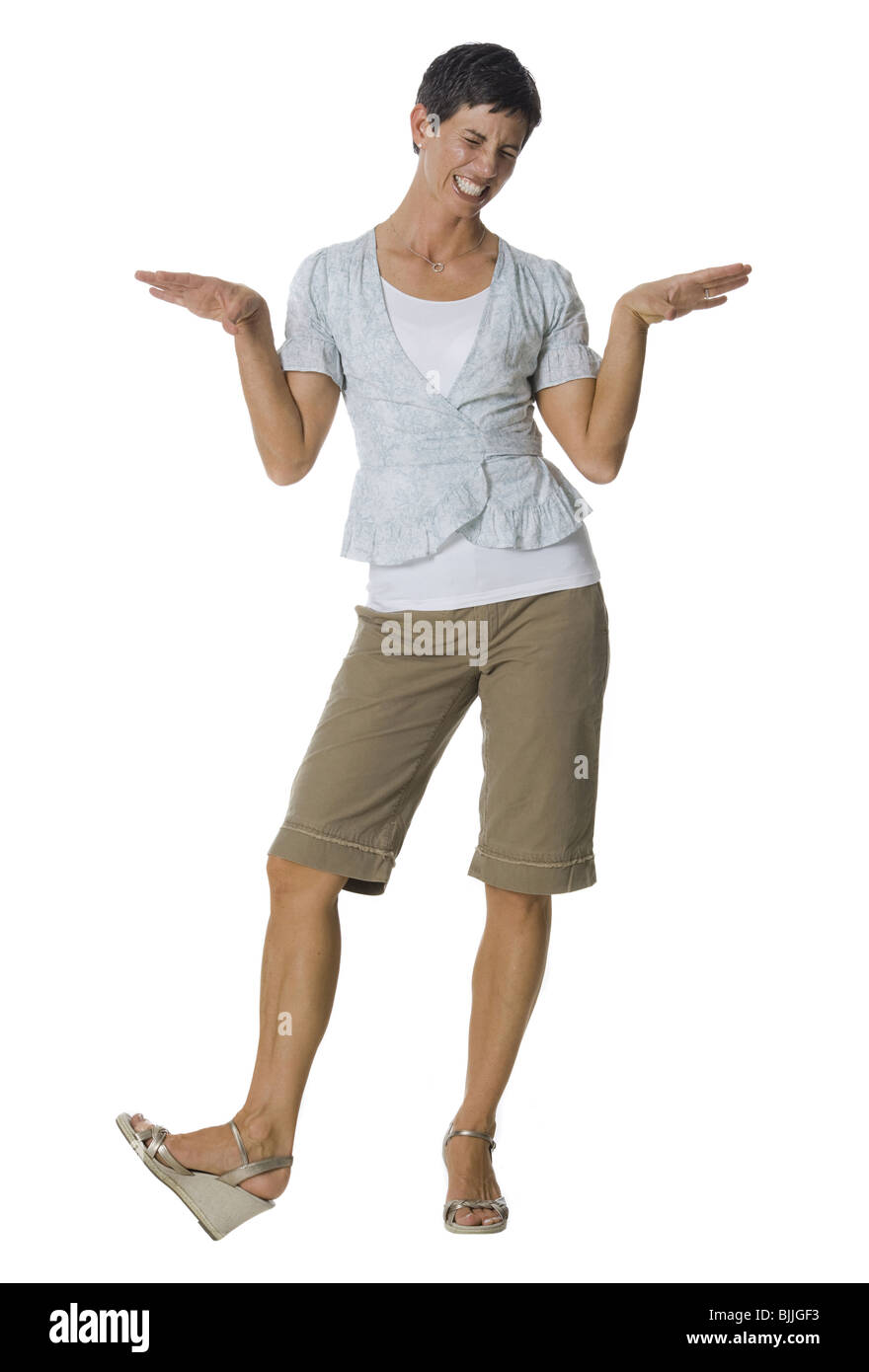 Woman standing and smiling Stock Photo - Alamy