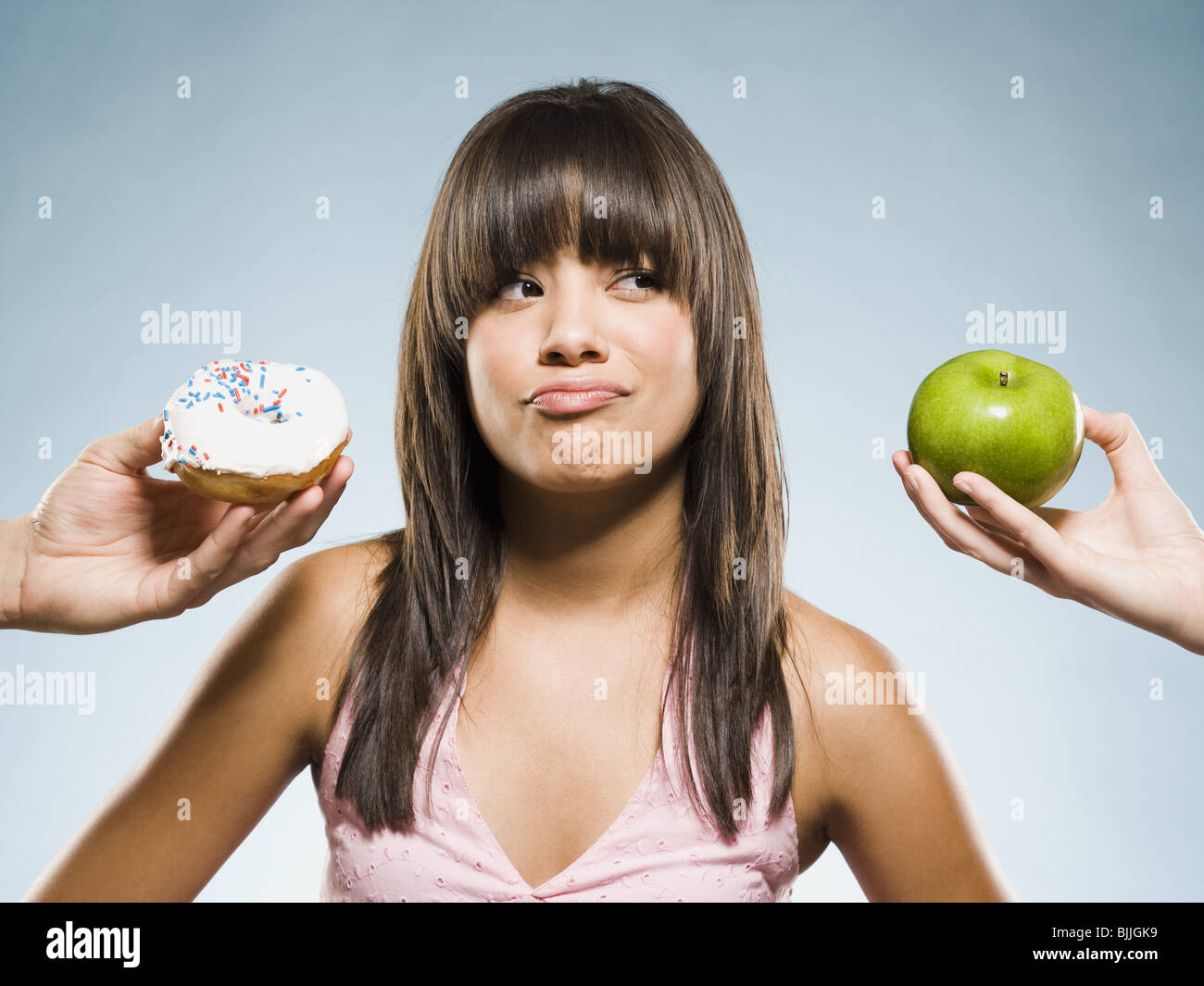 Woman choosing between foods hi-res stock photography and images - Alamy
