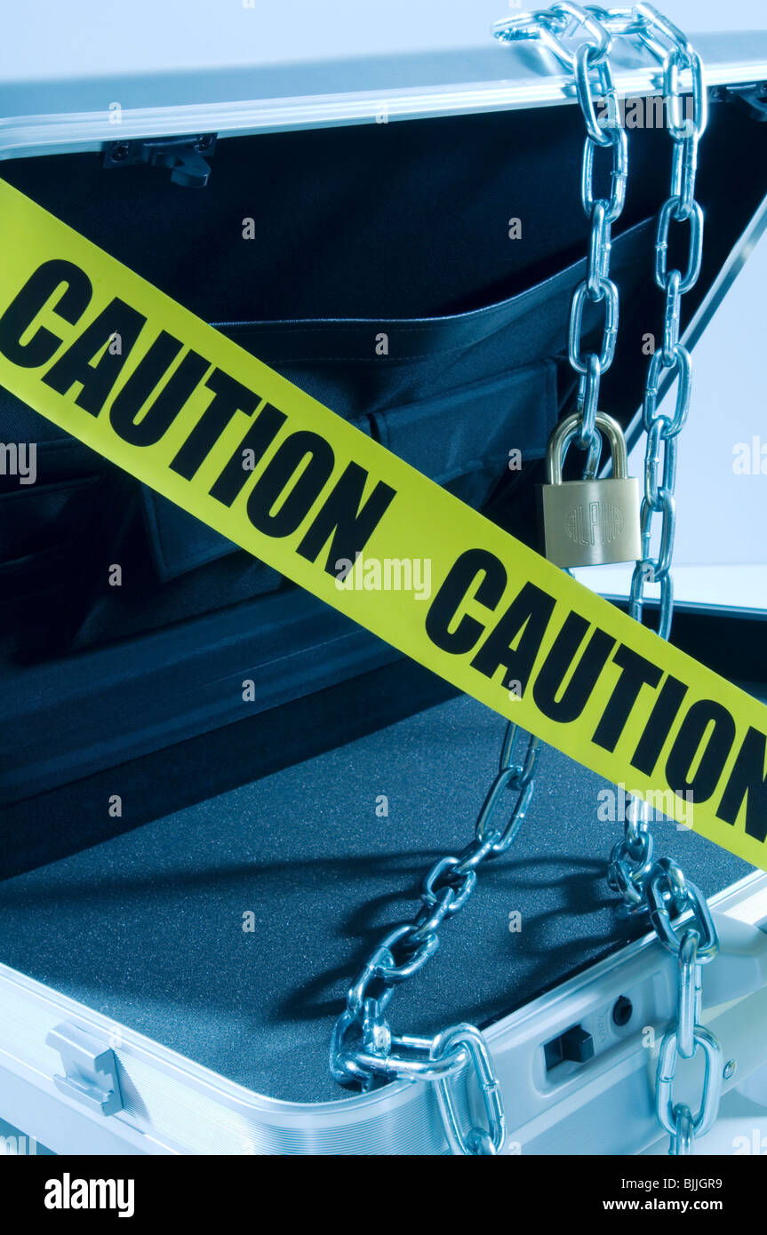 Case with laptop covered in chains and cordon tape Stock Photo - Alamy