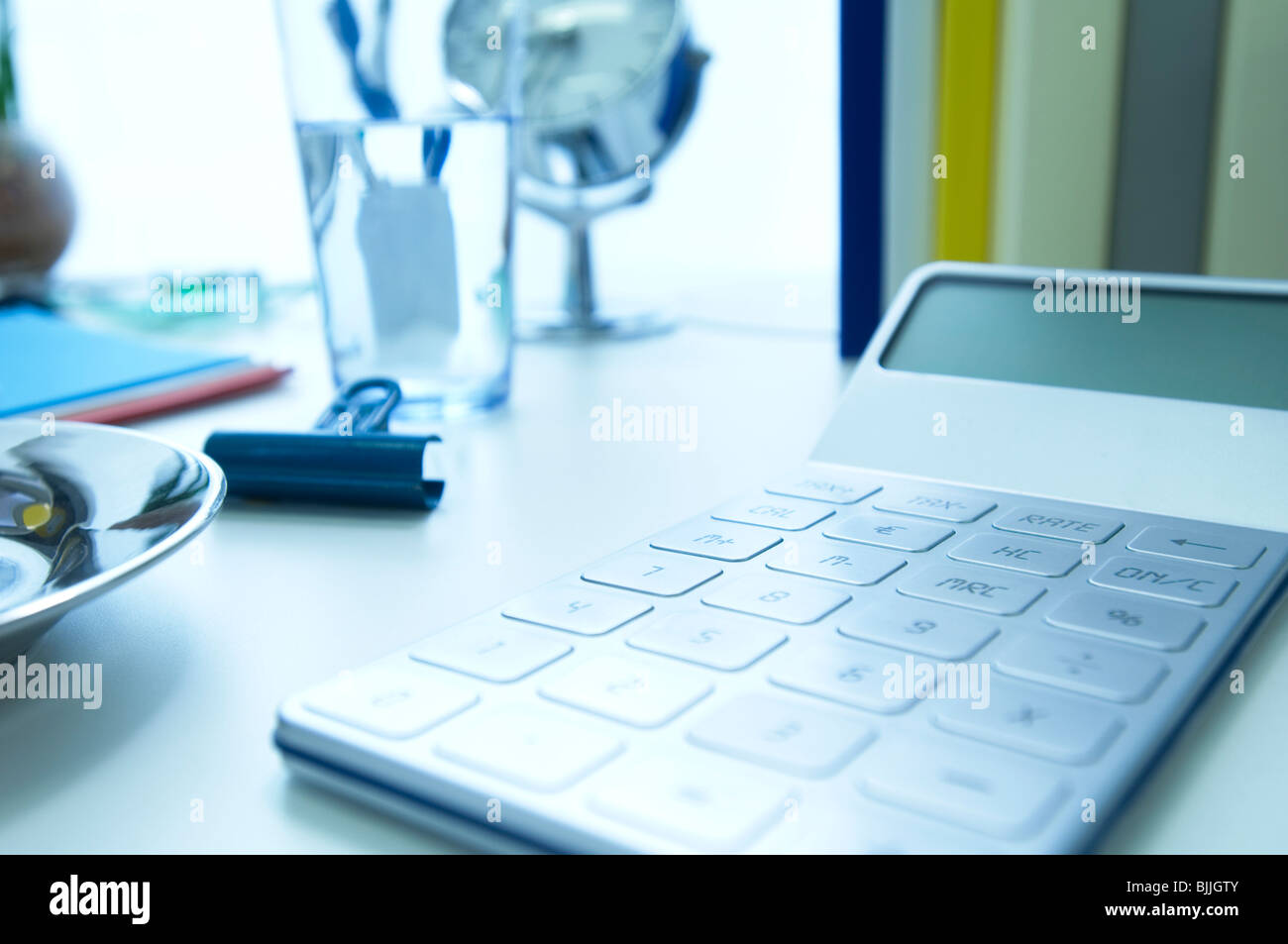 Calculator on office desk Stock Photo - Alamy