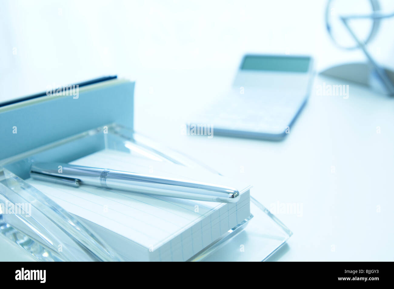 Pen and note pad on desk Stock Photo - Alamy