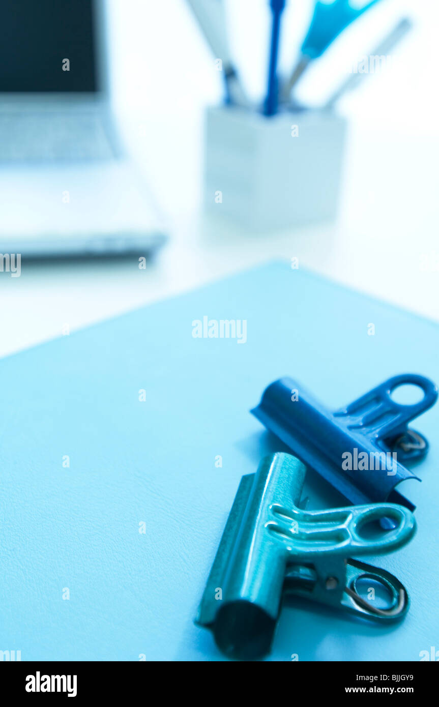 Binder clips on desk Stock Photo - Alamy