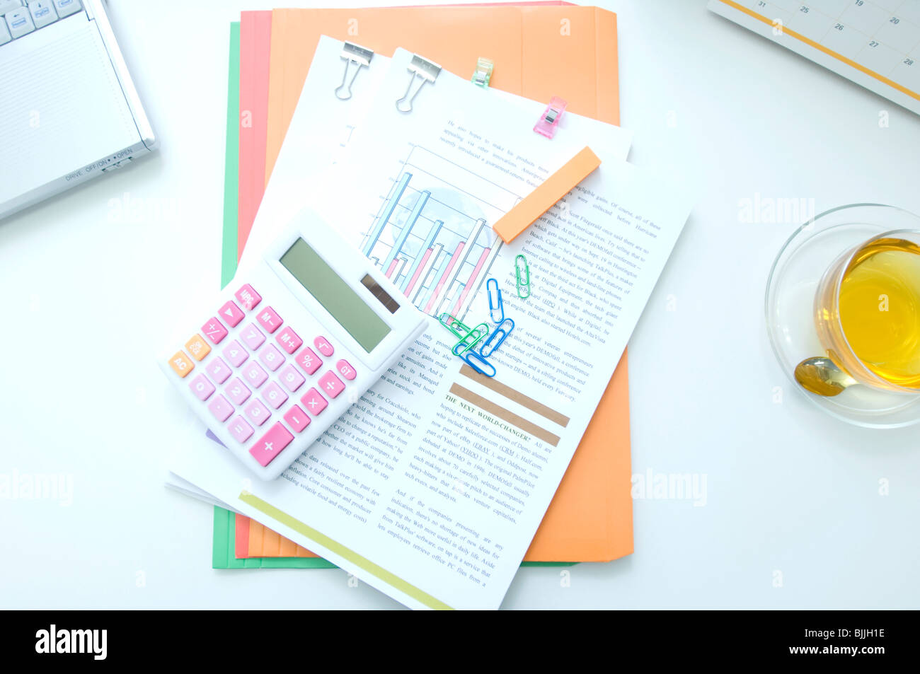 Calculator and files on desk Stock Photo - Alamy