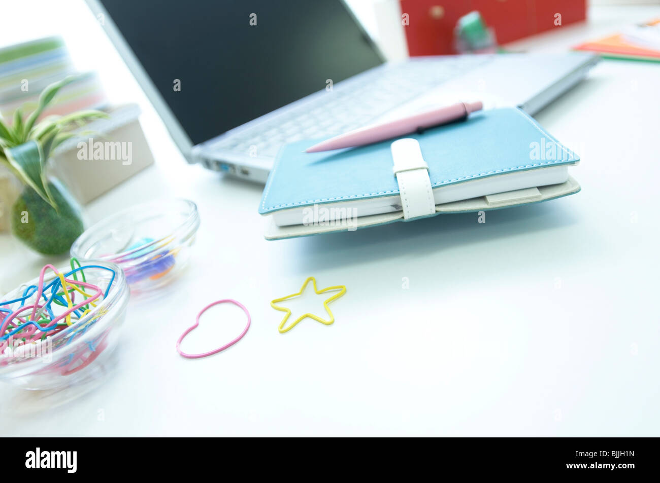 Laptop and notebook on desk Stock Photo - Alamy