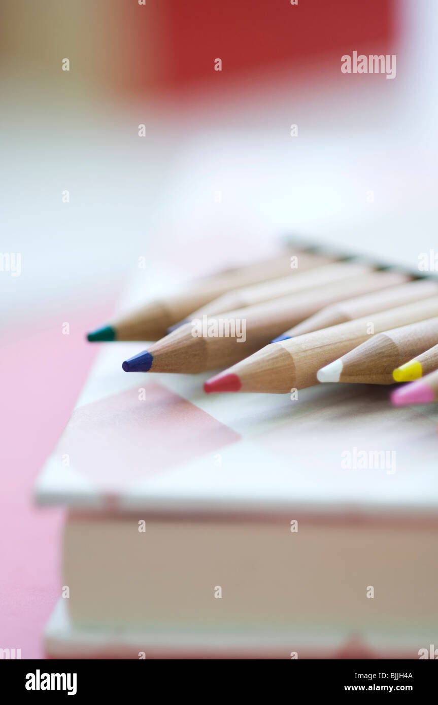 Coloring pencils on book Stock Photo - Alamy