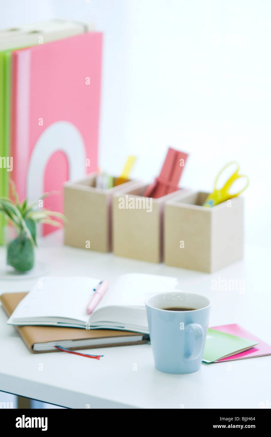 Desk with open notebook and coffee Stock Photo - Alamy
