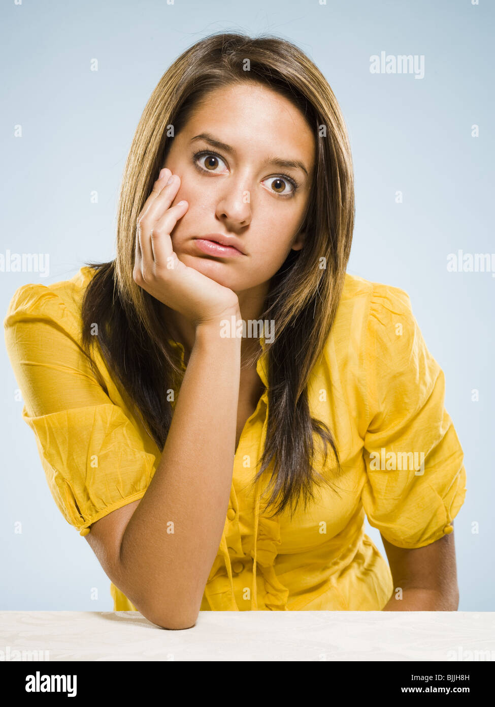Woman twirling hair in hand Stock Photo - Alamy
