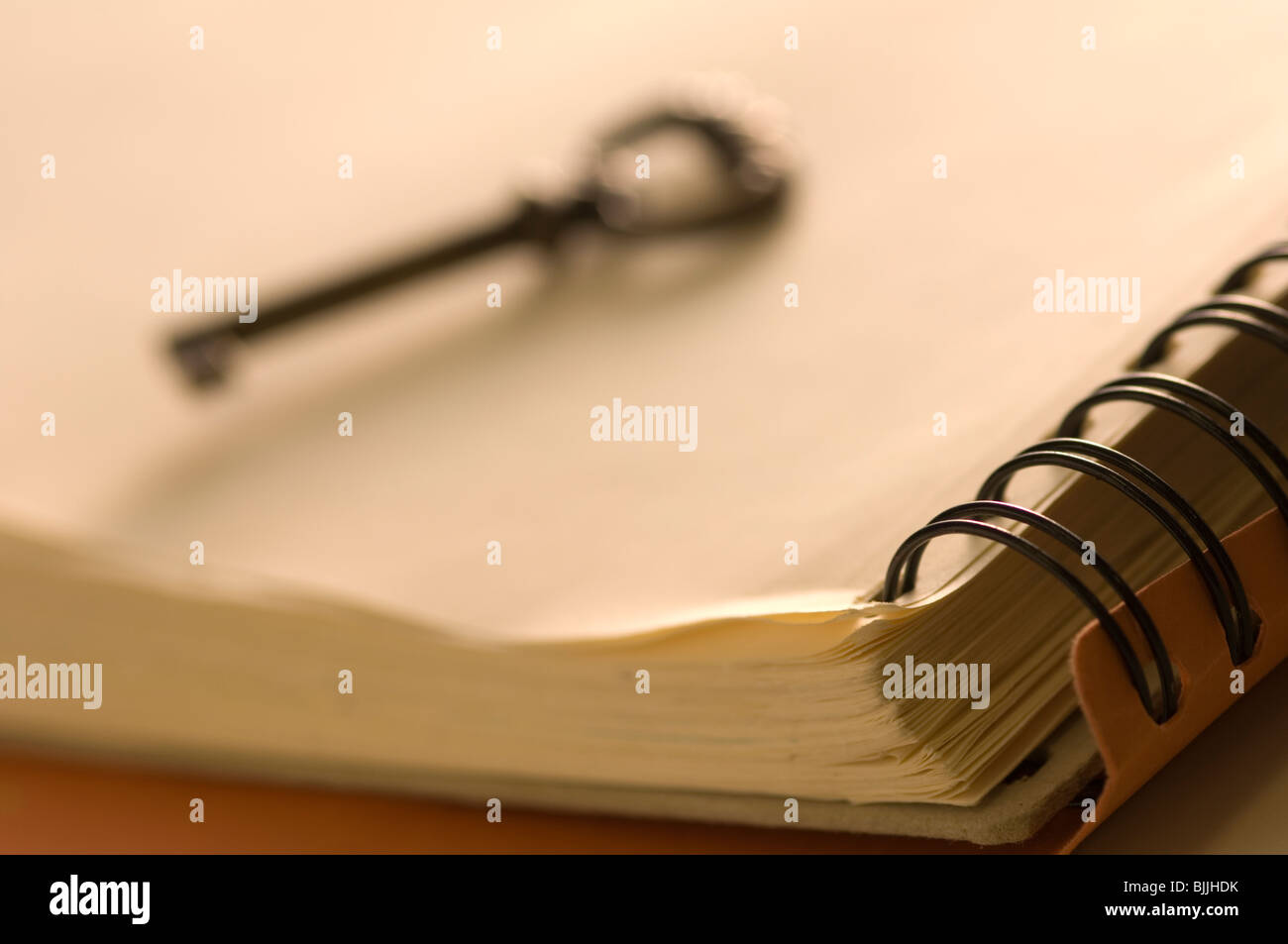 Antique key on a notebook Stock Photo - Alamy