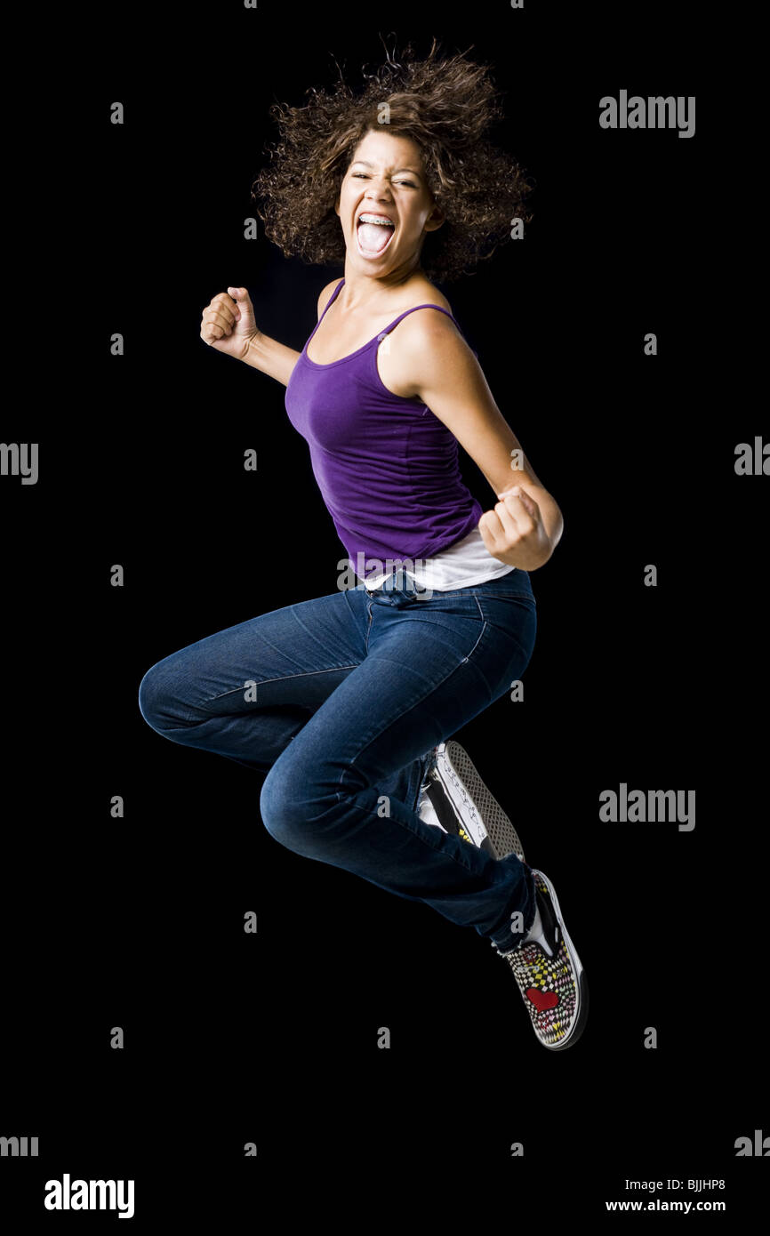 Girl leaping and smiling Stock Photo - Alamy