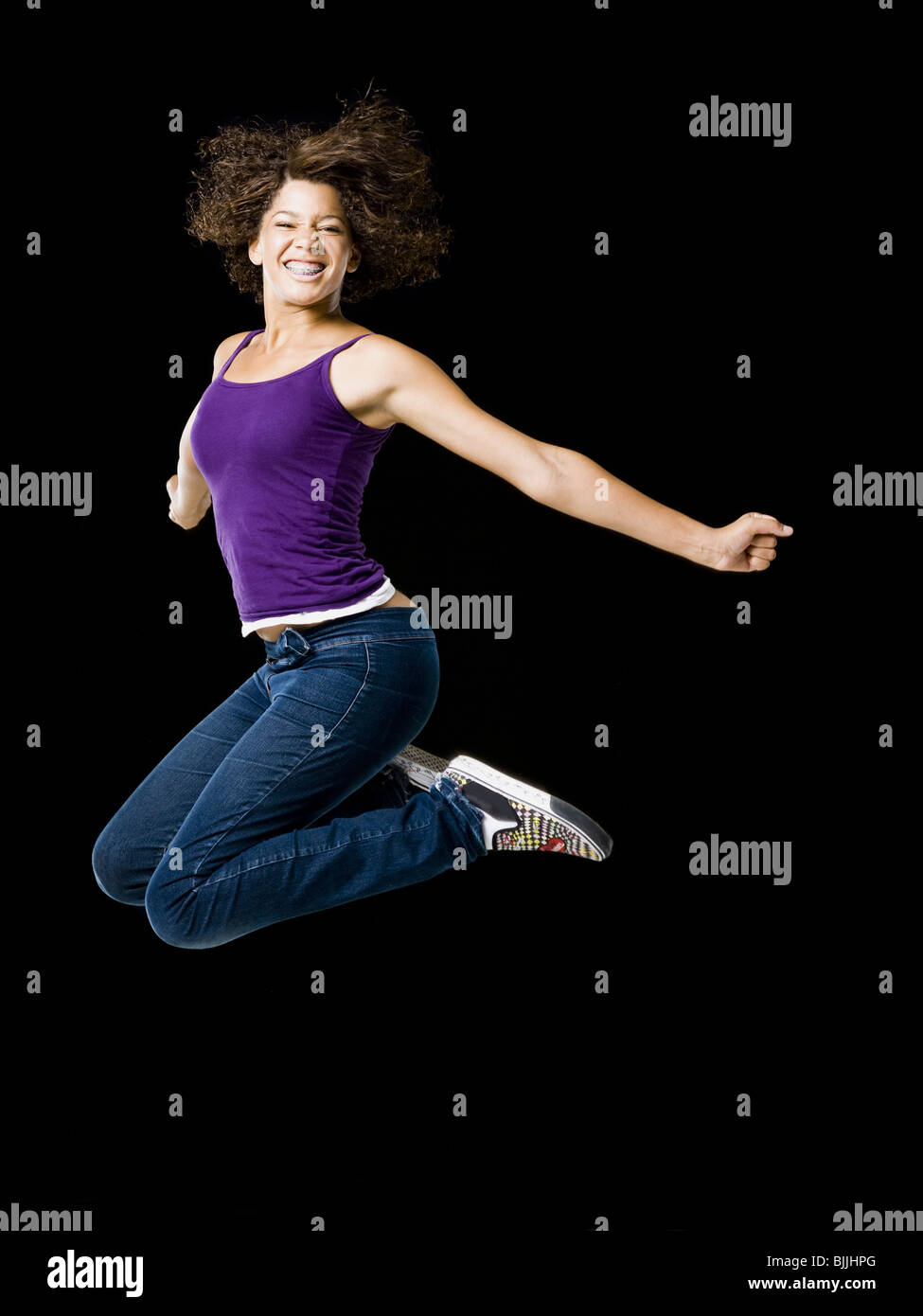 Girl leaping and smiling Stock Photo - Alamy