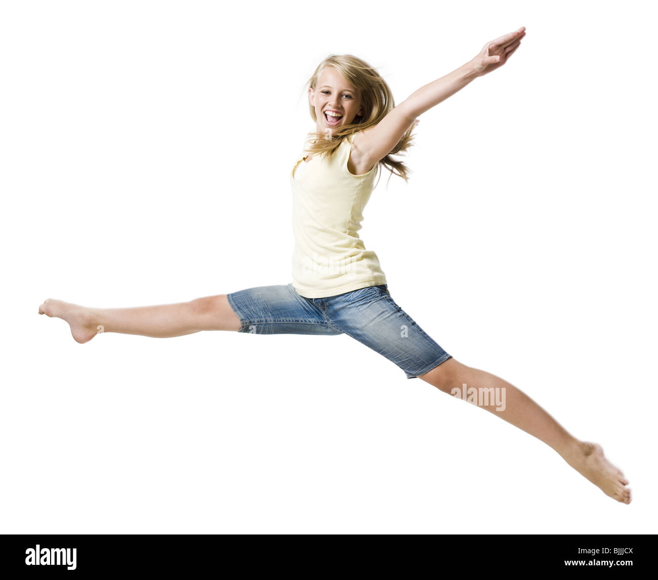 Girl leaping and smiling with arms up Stock Photo - Alamy