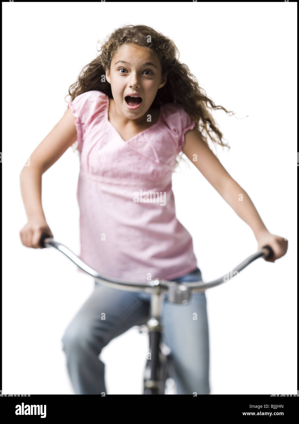 Girl riding bicycle smiling Stock Photo - Alamy