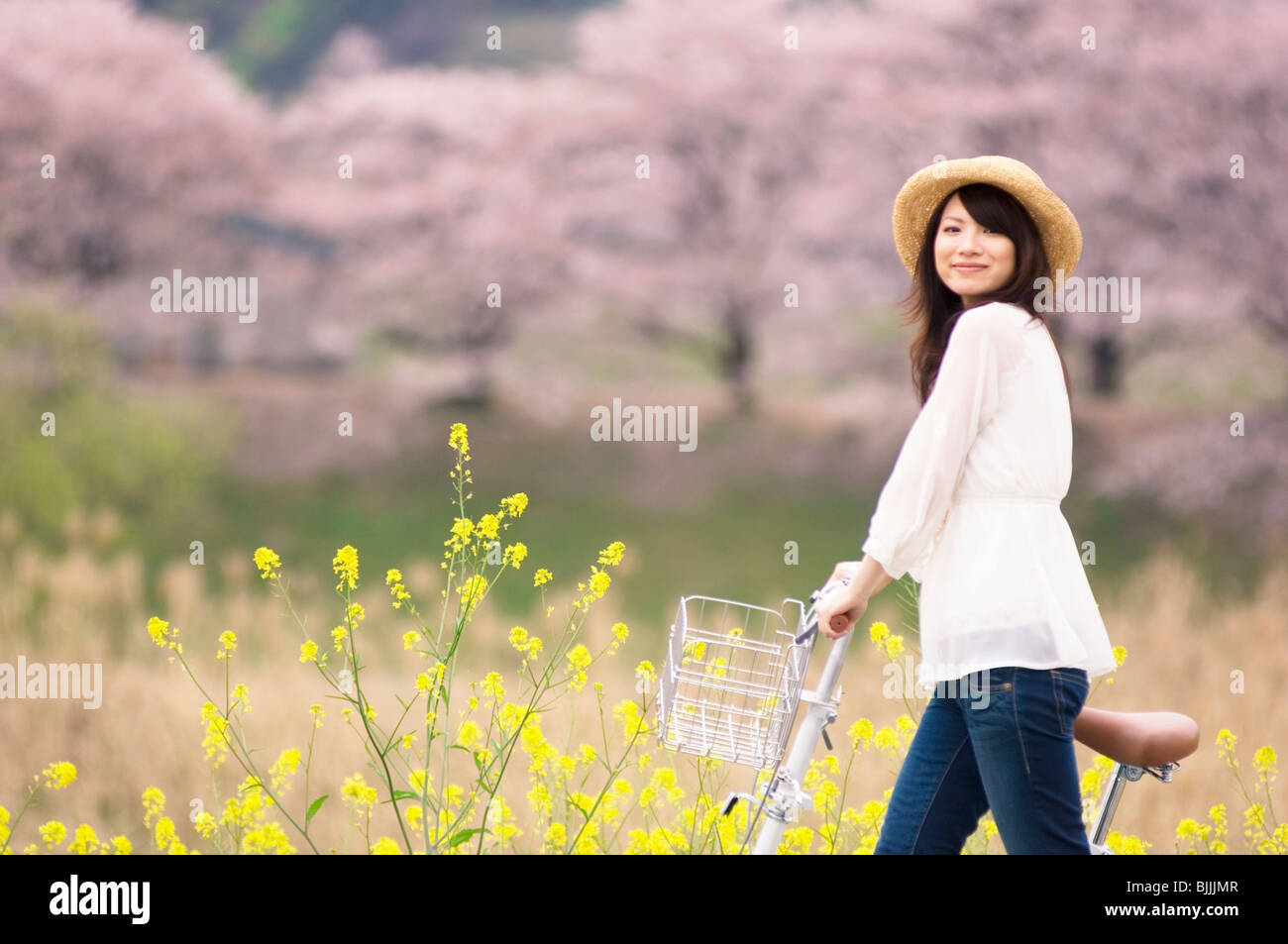 Woman cycling through spring landscape Stock Photo - Alamy