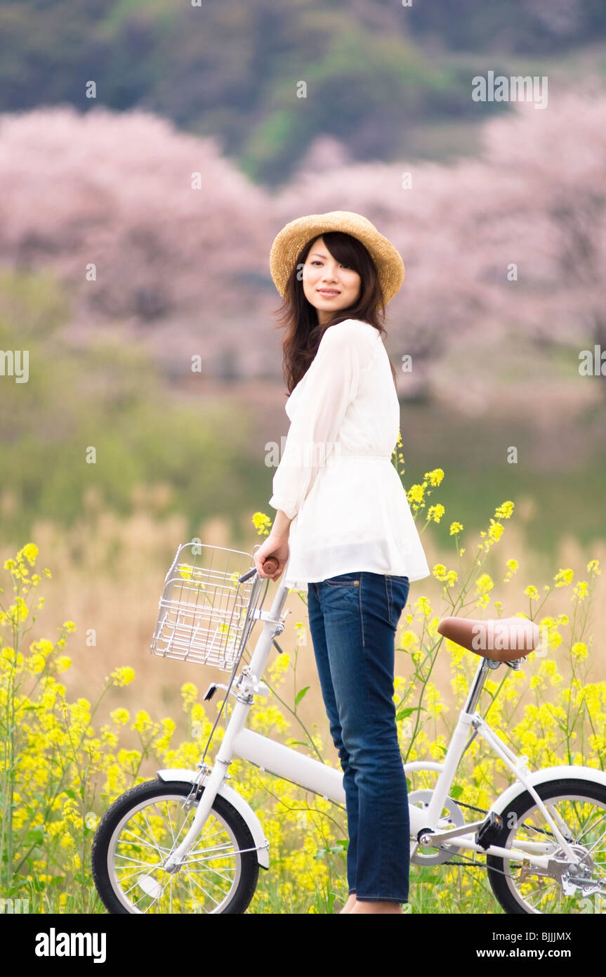 Woman cycling through spring landscape Stock Photo - Alamy