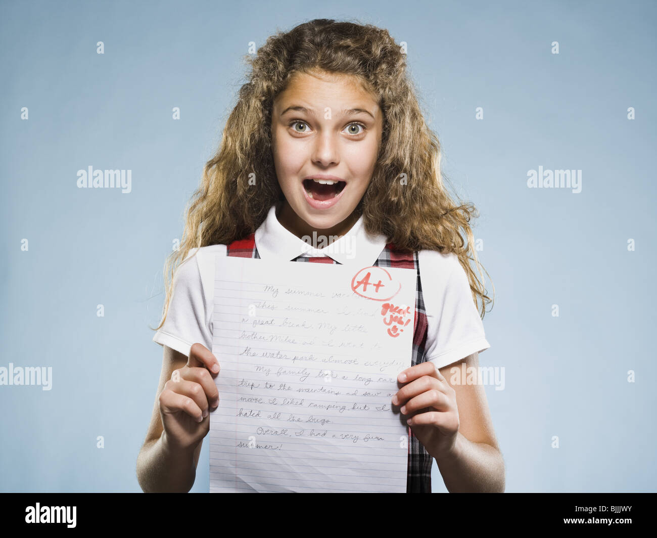 Girl with A plus paper smiling Stock Photo - Alamy