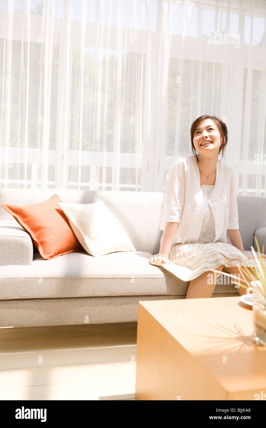 Woman sitting indoors high key selective hi-res stock photography and ...