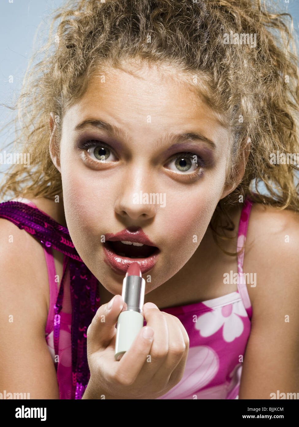 Closeup of girl applying lipstick Stock Photo - Alamy
