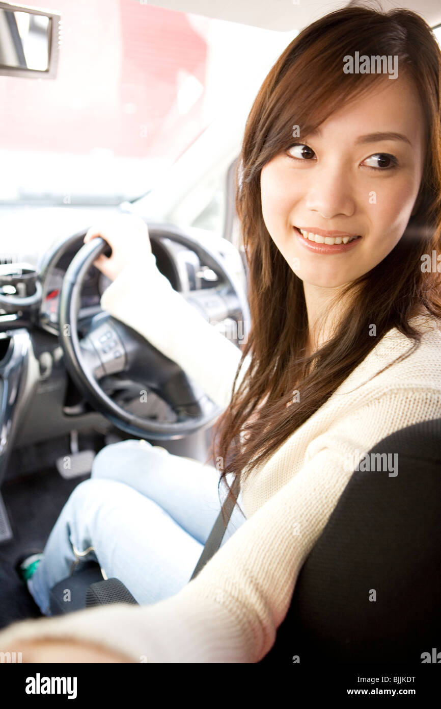 Woman driving reversing car looking hi-res stock photography and images ...