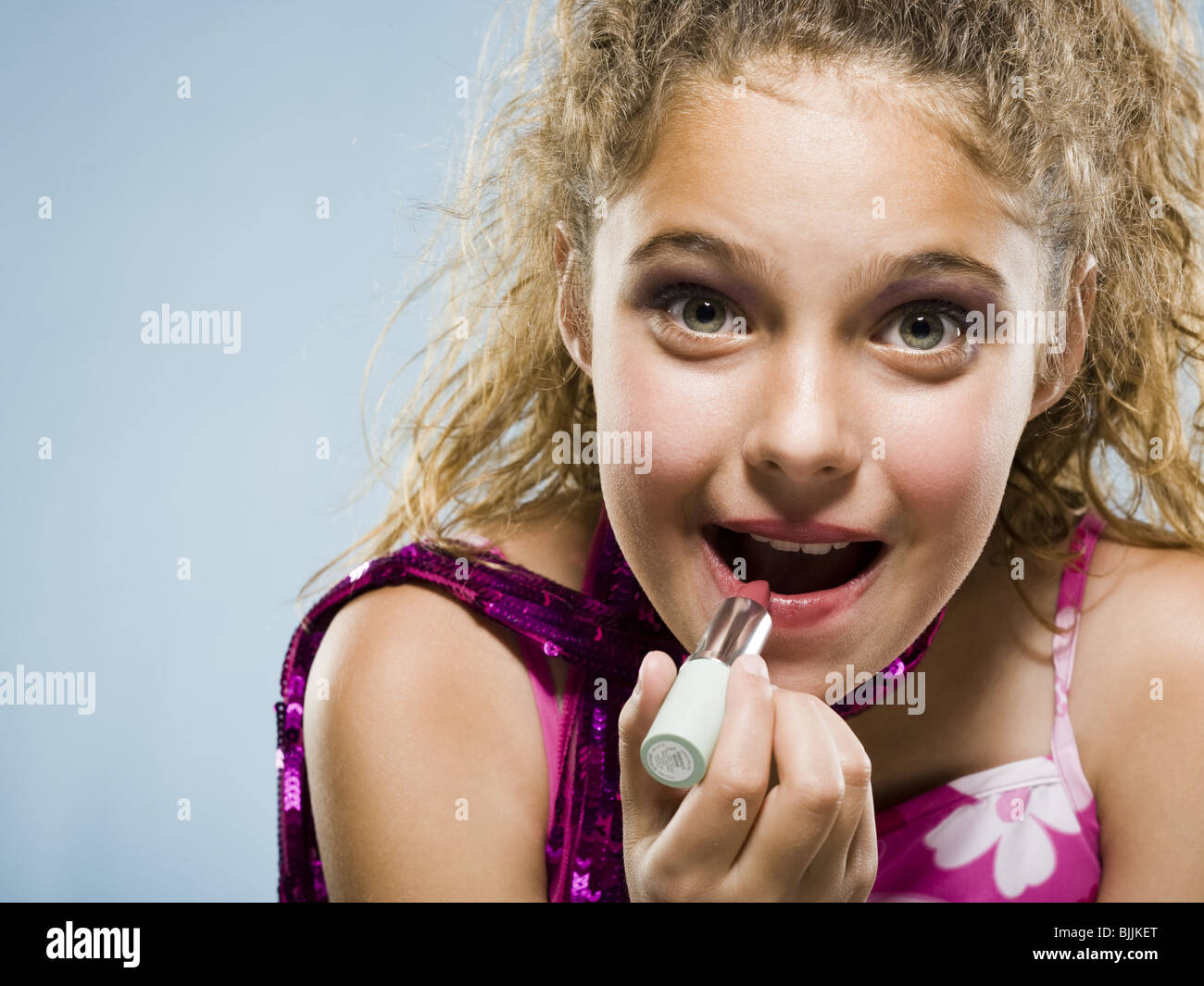 Closeup of girl applying lipstick Stock Photo - Alamy