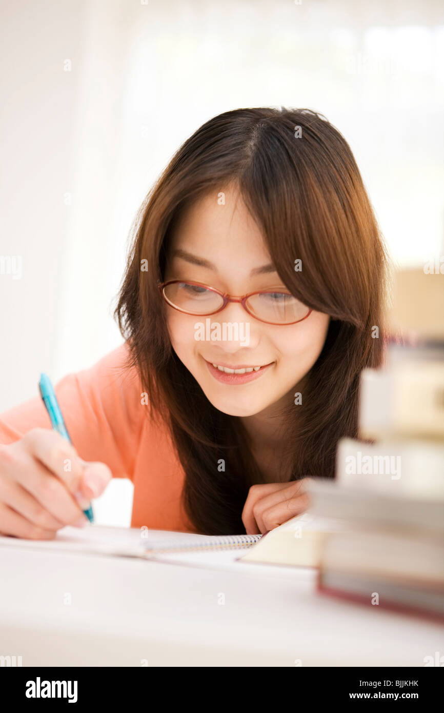 Woman studying at her desk Stock Photo - Alamy