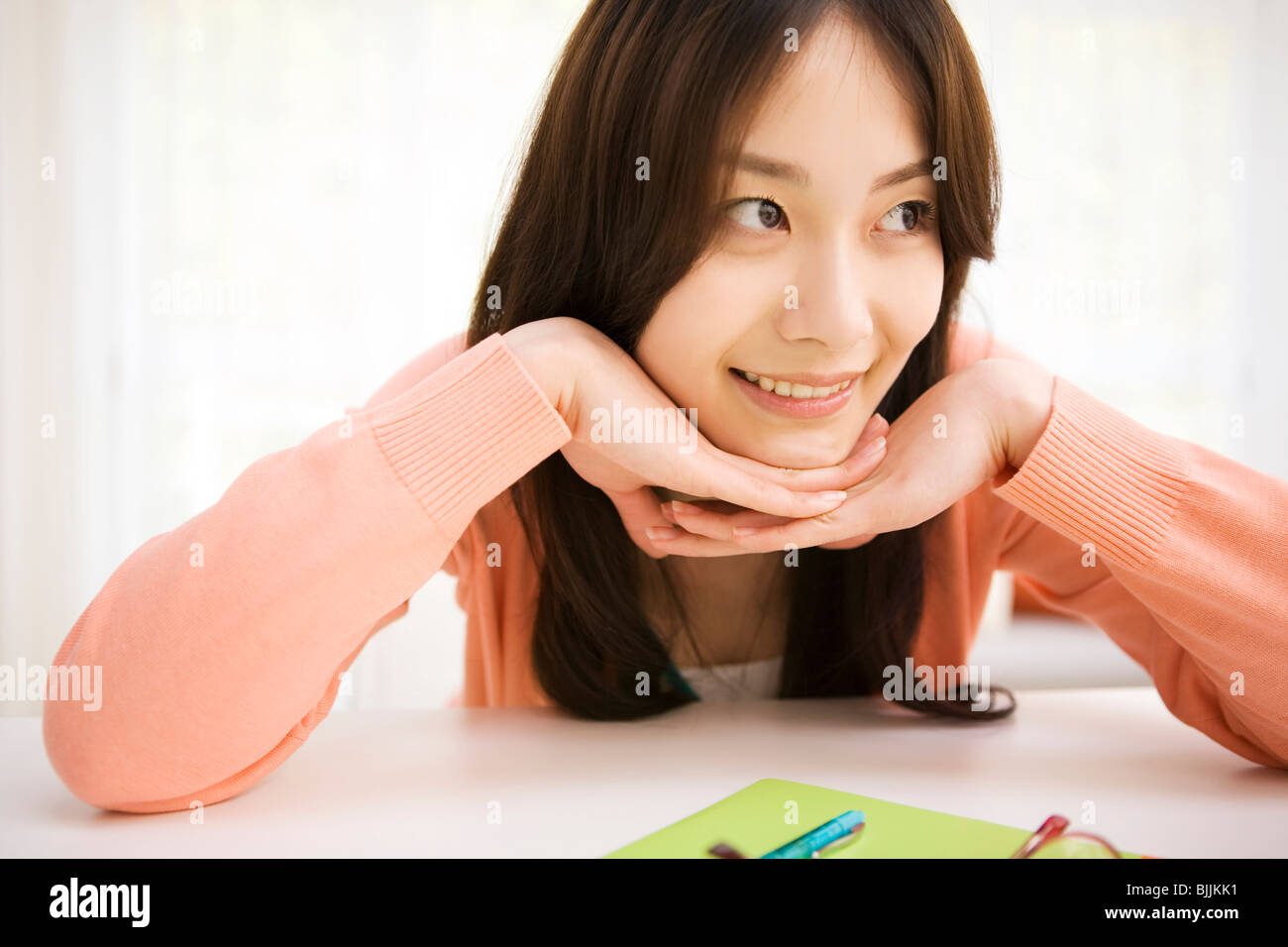 Woman daydreaming at her desk Stock Photo - Alamy