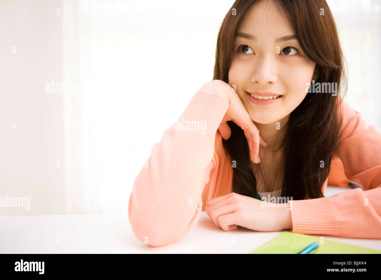 Woman daydreaming at her desk Stock Photo - Alamy