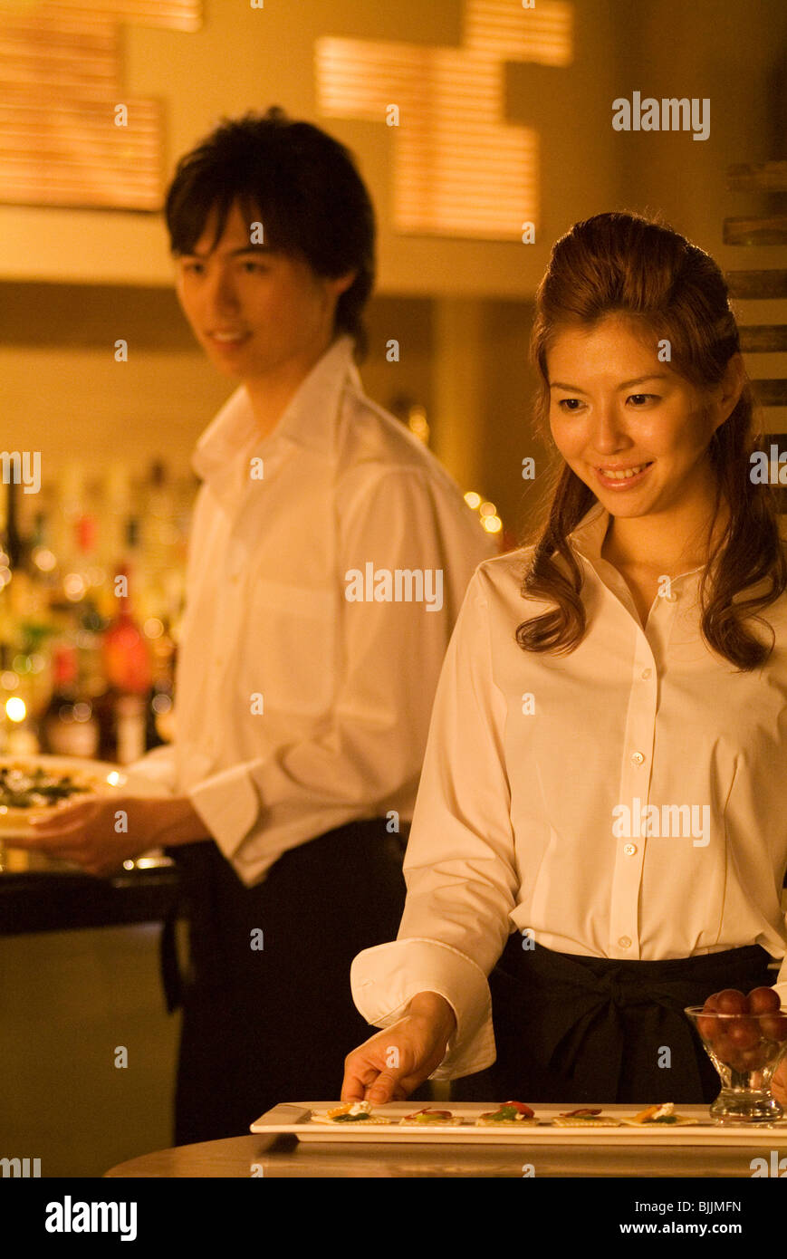 Waitress serving food night hi-res stock photography and images - Alamy