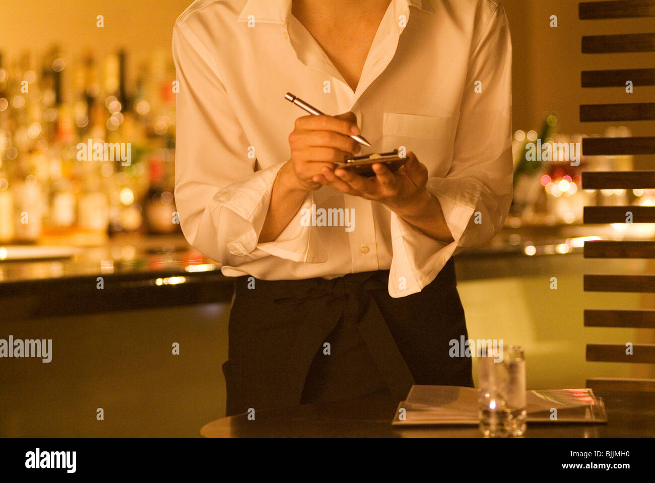 Waiter taking a customer's order Stock Photo - Alamy