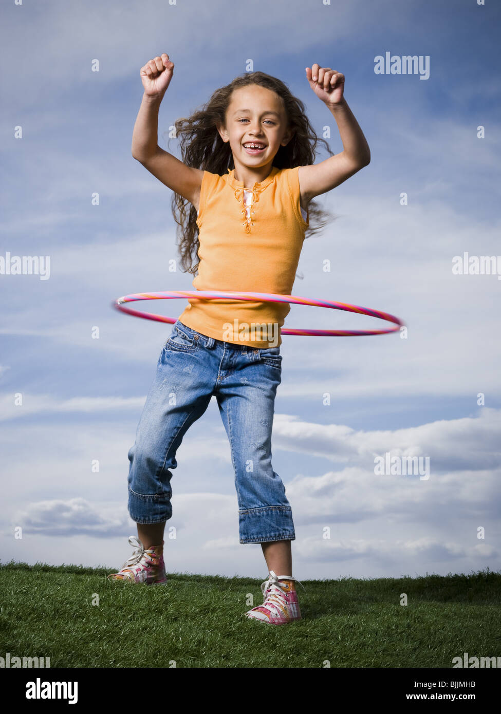 Girl playing with hula hoop outdoors Stock Photo - Alamy