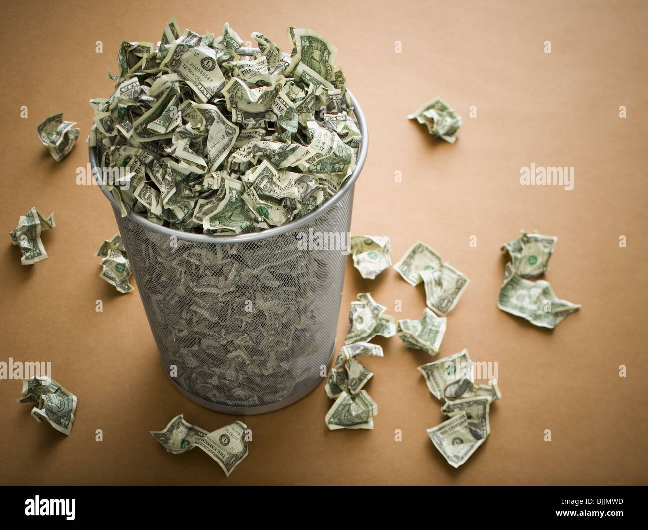 Waste paper basket with crumpled money Stock Photo - Alamy