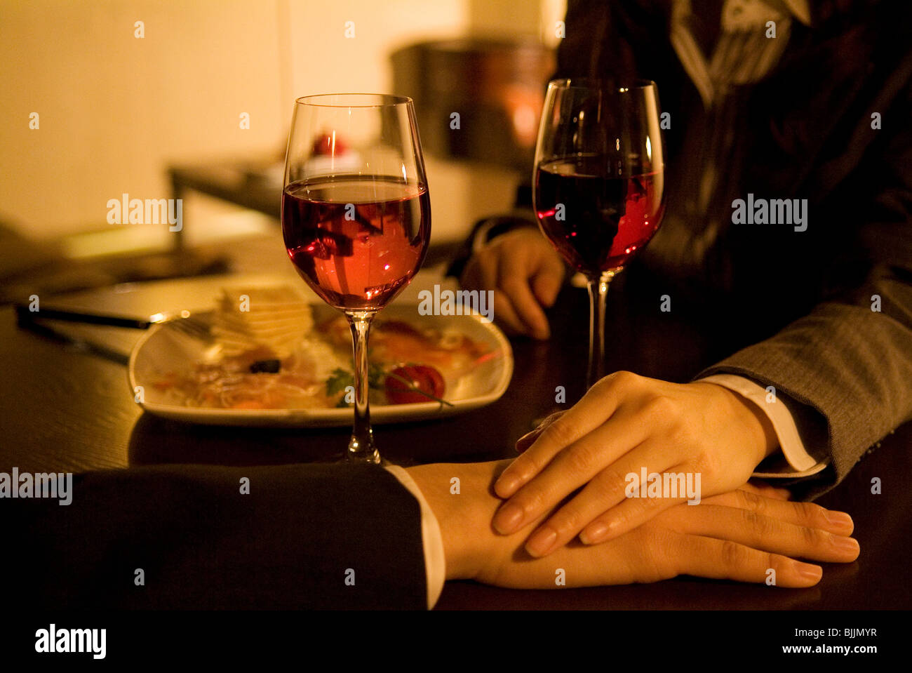 Couple hands touching dinner hi-res stock photography and images - Alamy