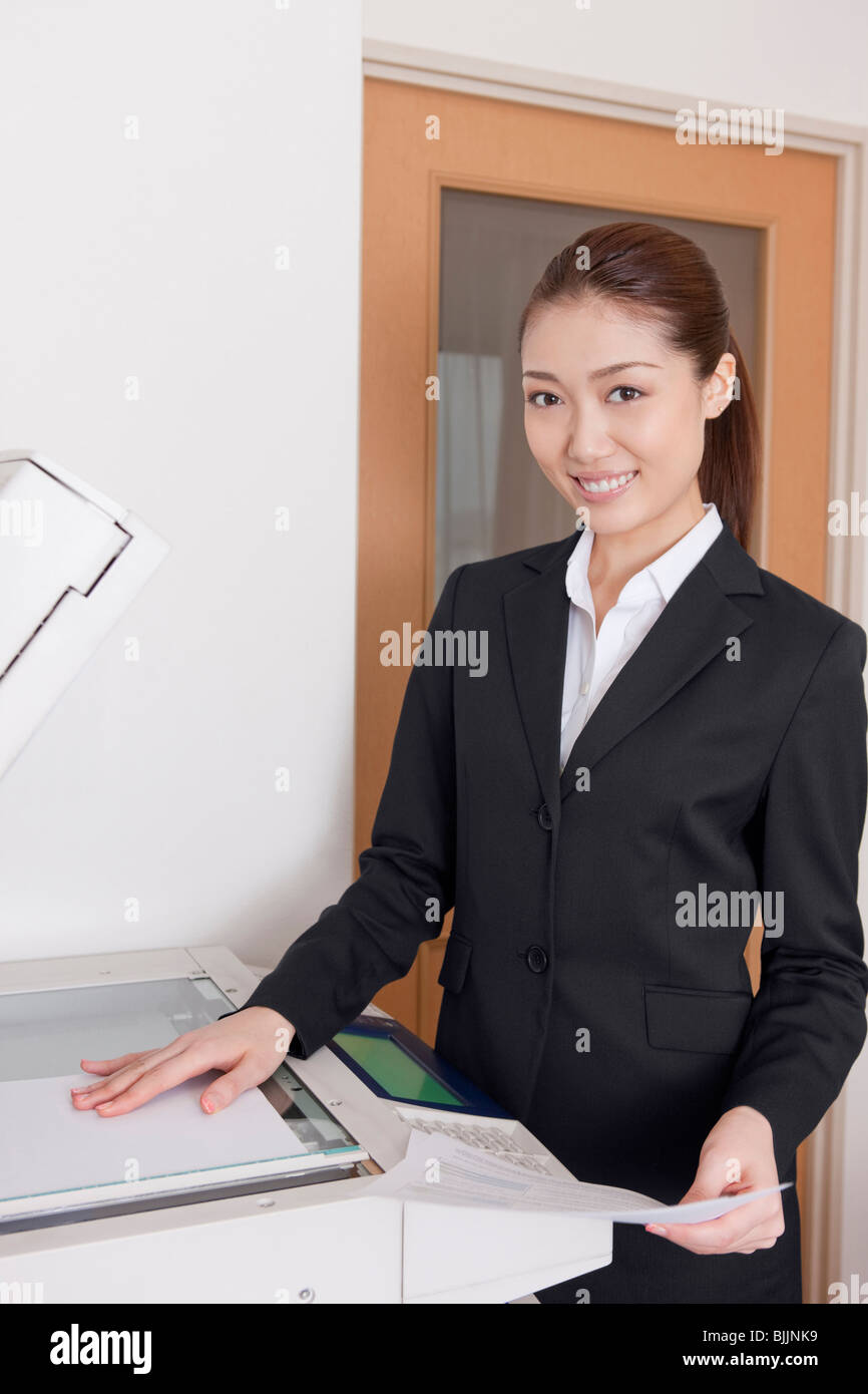 Young businesswoman copying documents Stock Photo - Alamy