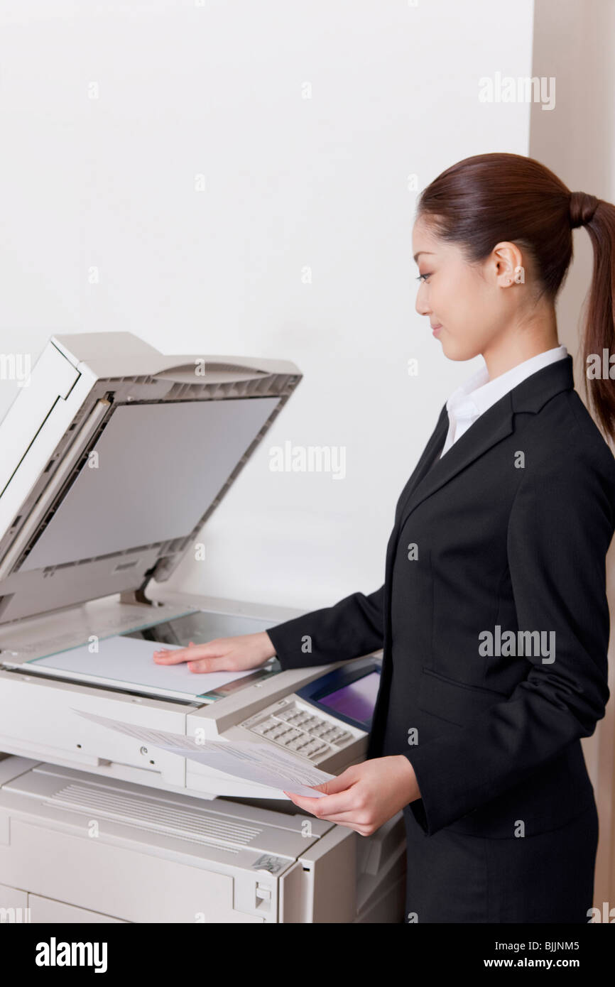 Young businesswoman copying documents Stock Photo - Alamy