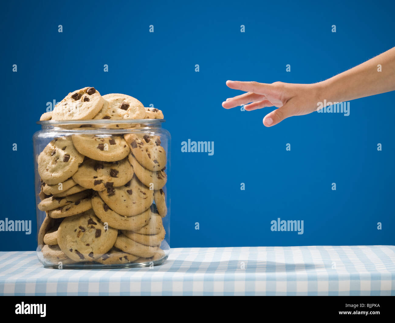 Hand reaching for chocolate chip cookie jar Stock Photo - Alamy