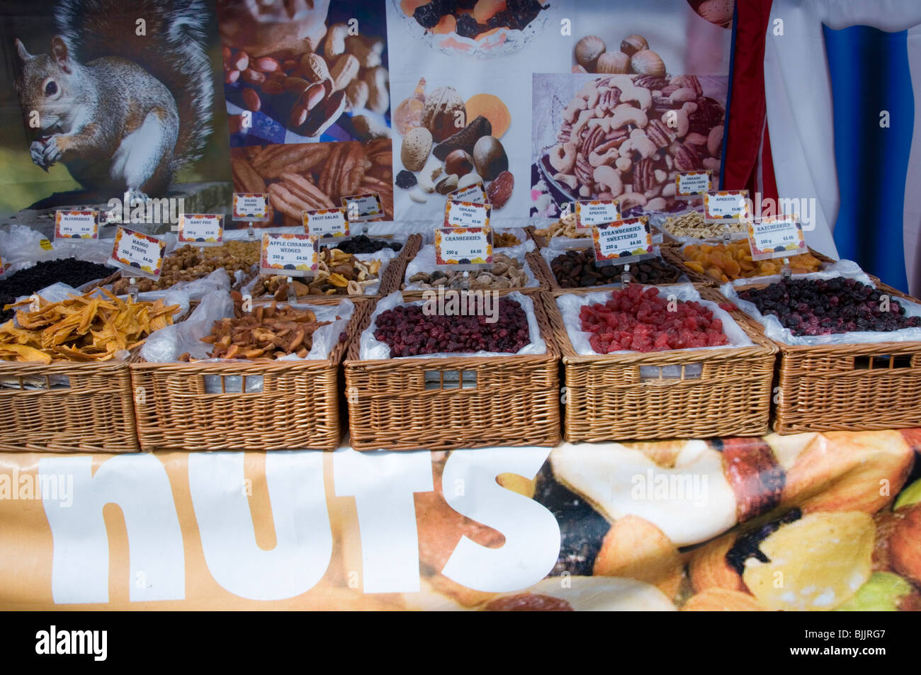 Dried fruit in baskets on a fruit and nut stall at a French market in ...