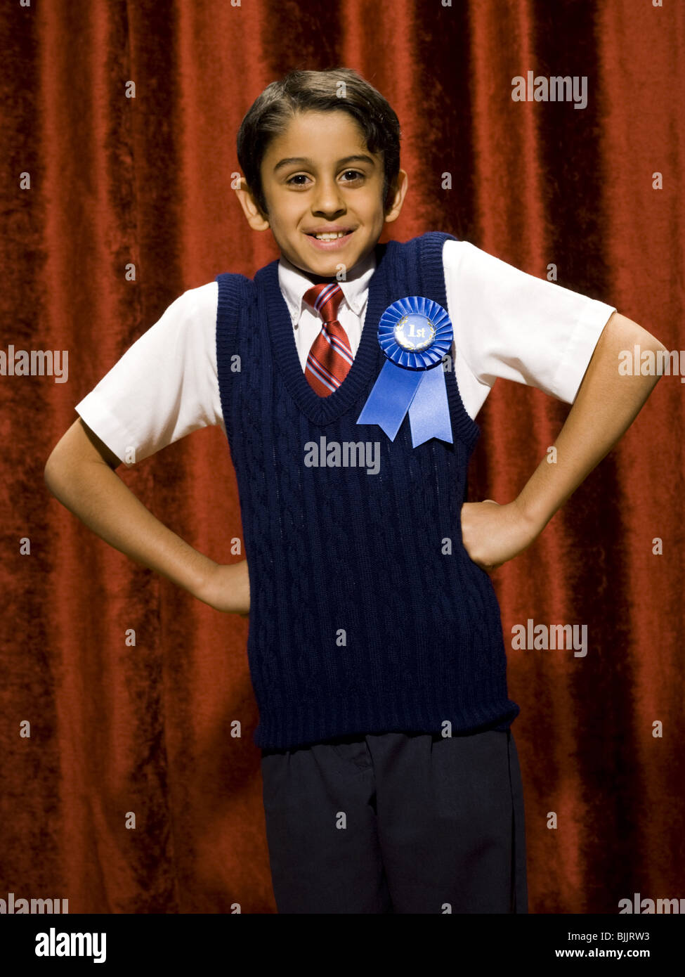 Boy with blue ribbon smiling with arms crossed Stock Photo - Alamy
