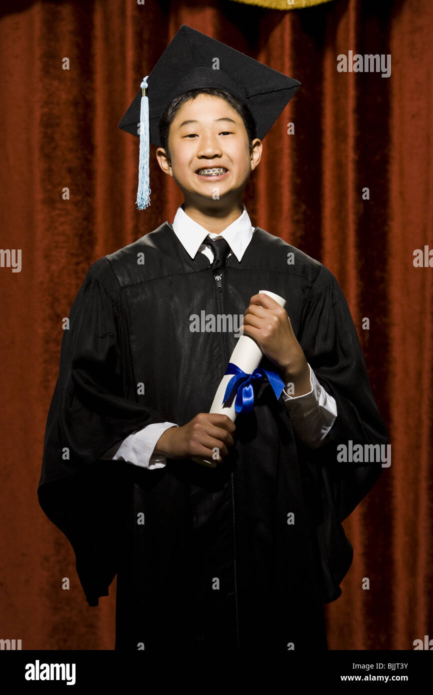 Boy graduate with mortar board and diploma smiling with braces Stock ...