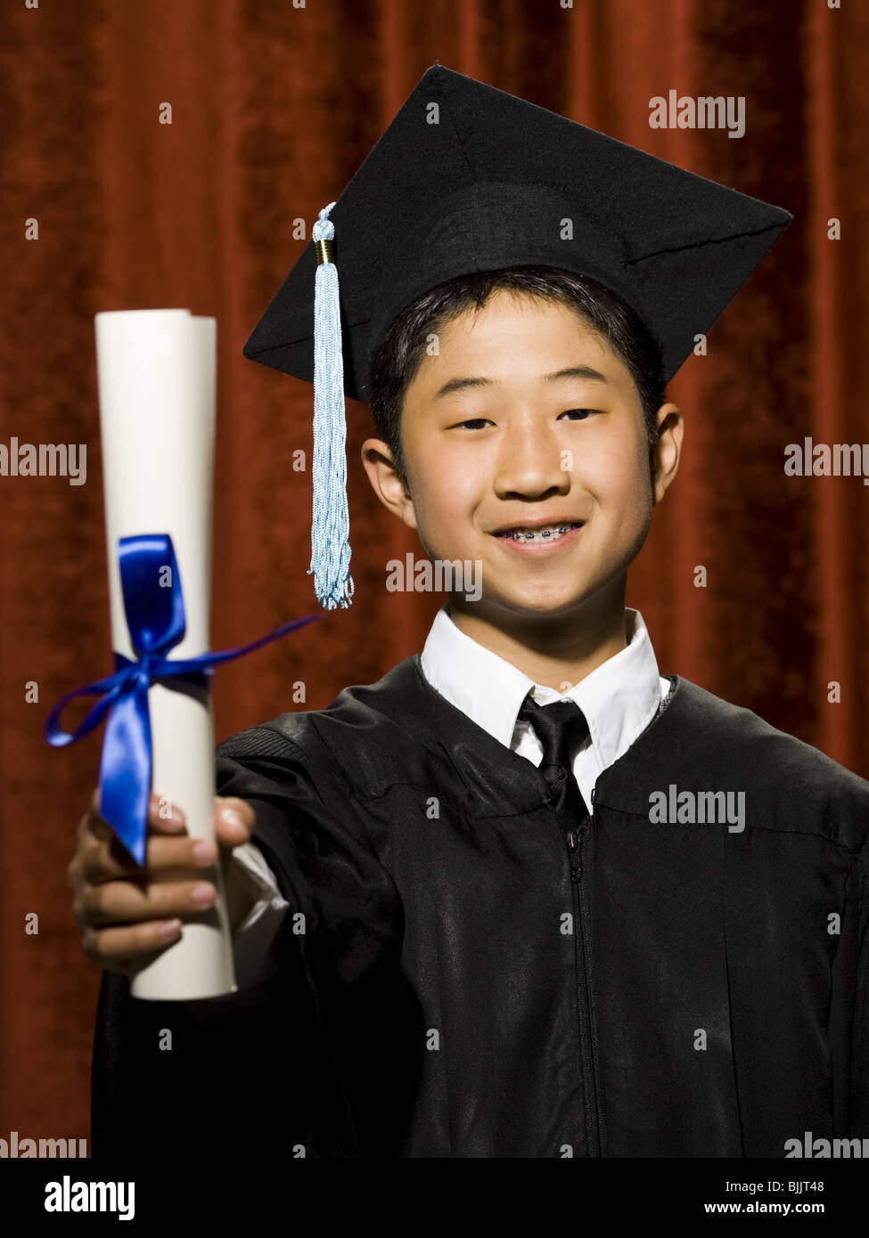 Boy graduate with mortar board and diploma smiling with braces Stock ...