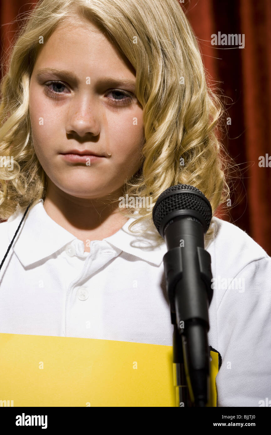 Girl contestant standing at microphone crying Stock Photo - Alamy