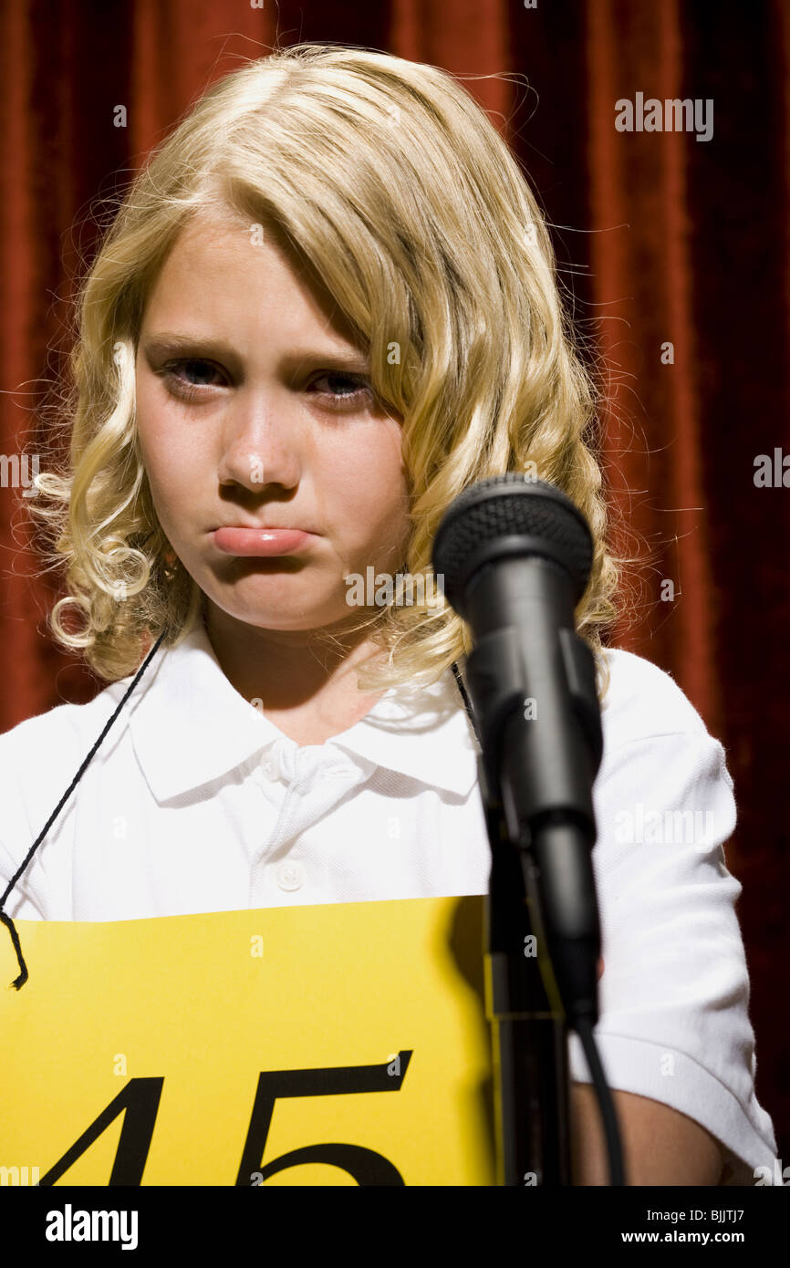 Girl contestant standing at microphone crying Stock Photo - Alamy