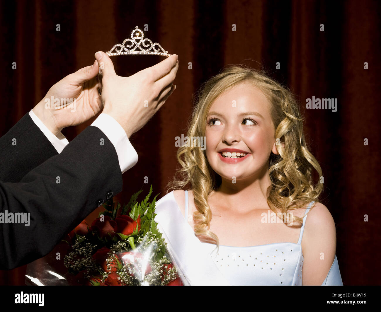 Beauty pageant winner smiling and holding roses Stock Photo - Alamy