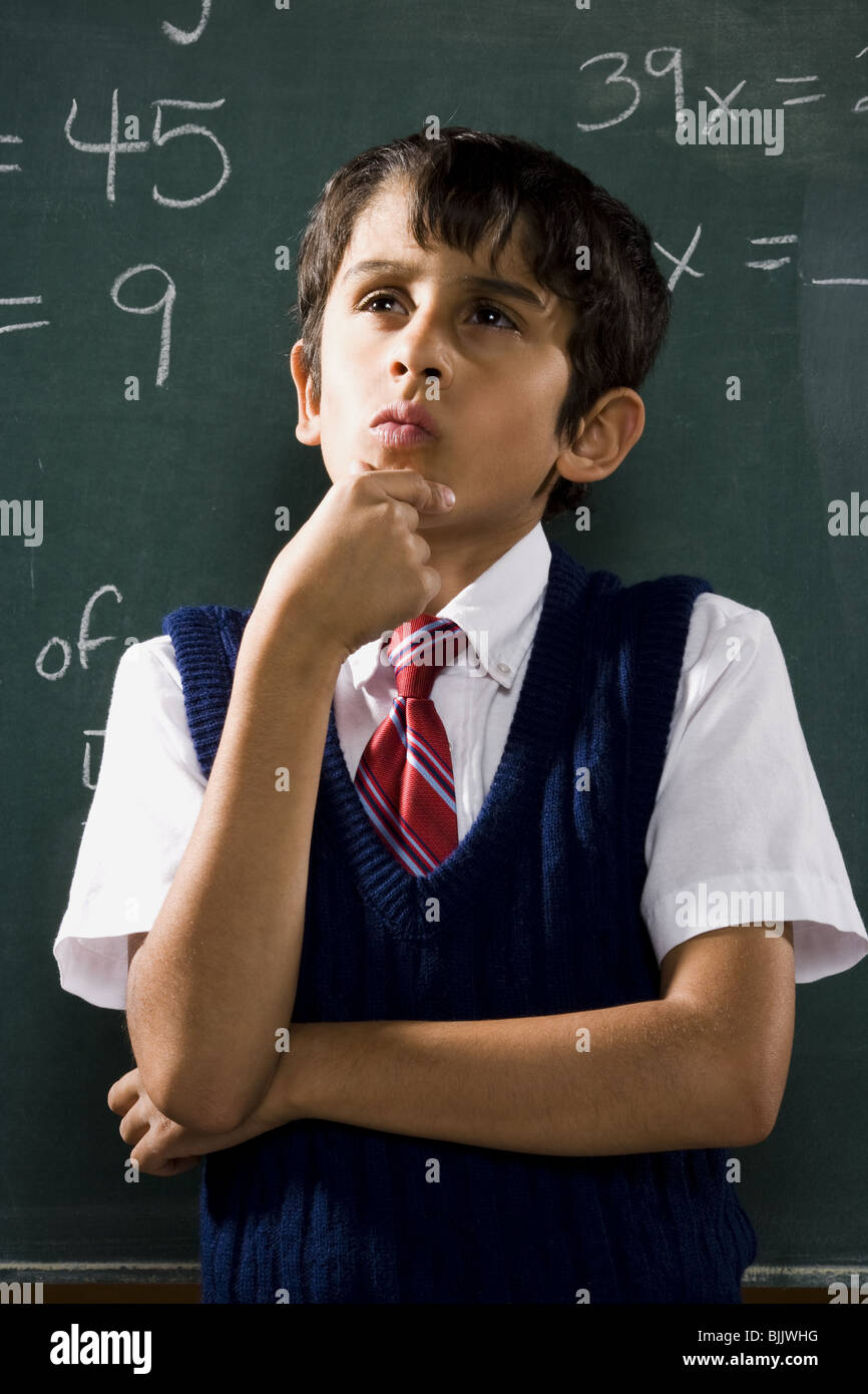 Boy at chalkboard with math formulas thinking Stock Photo - Alamy